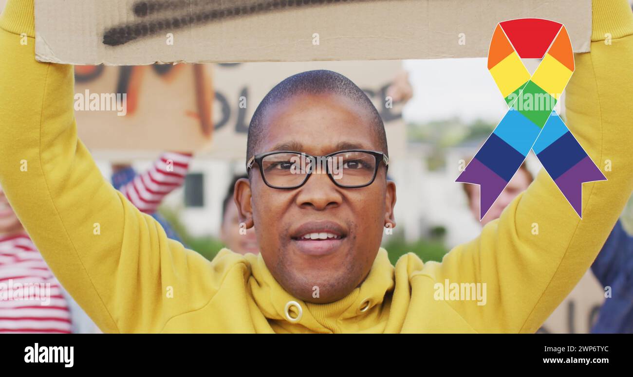 Image of rainbow ribbon over african american male protester with ...