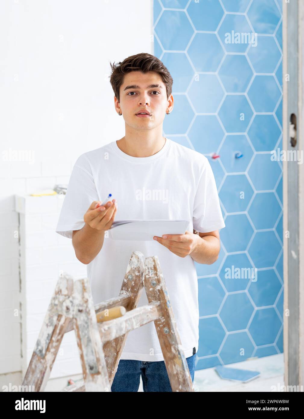 Interested guy making notes while planning house overhaul Stock Photo ...