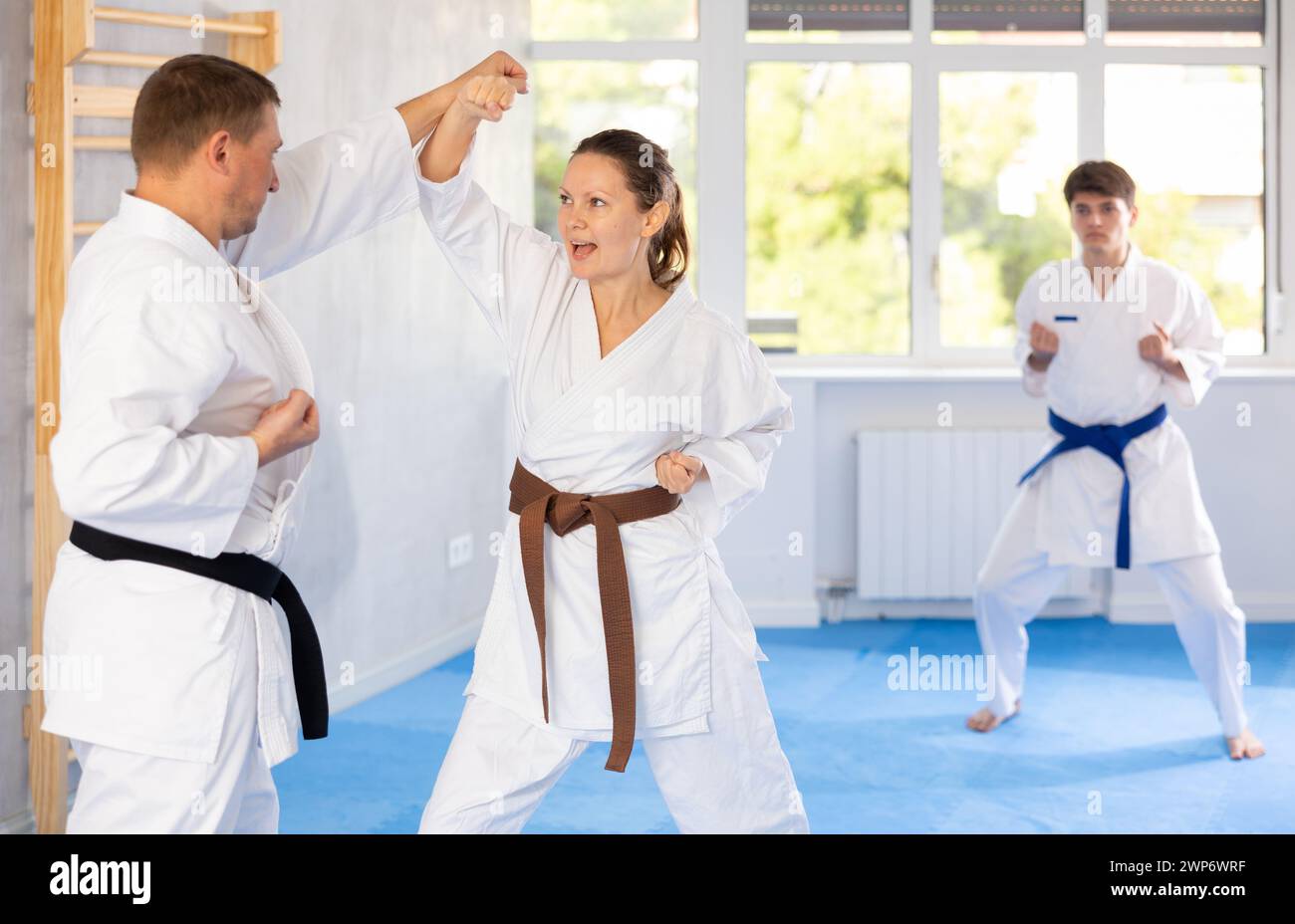 Man and woman train to perform basic defensive attacking actions during ...