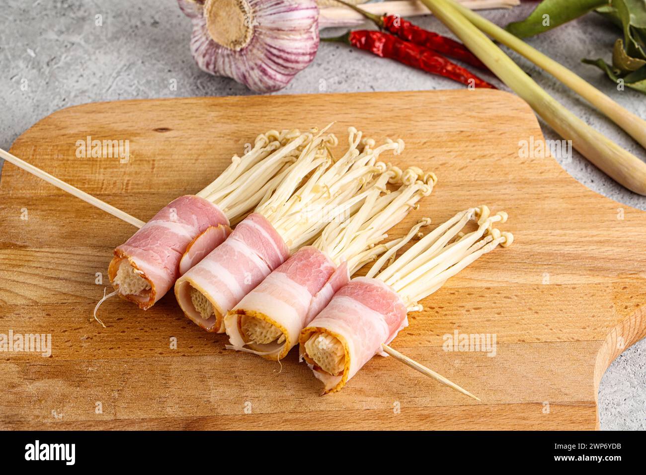 Tasty Raw Enoki mushroom with bacon Stock Photo - Alamy