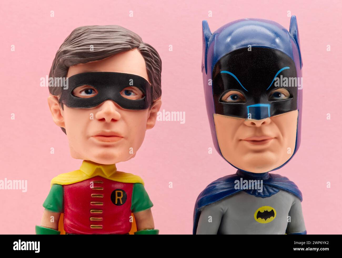 Batman 1966 and Robin bobbleheads from dc comics isolated on pink ...