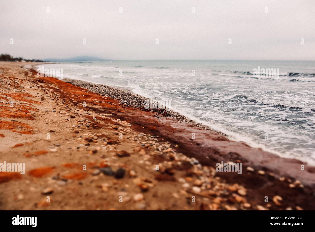 Natural colorful sea stones, rocks on a sandy beach, seashore. Abstract ...