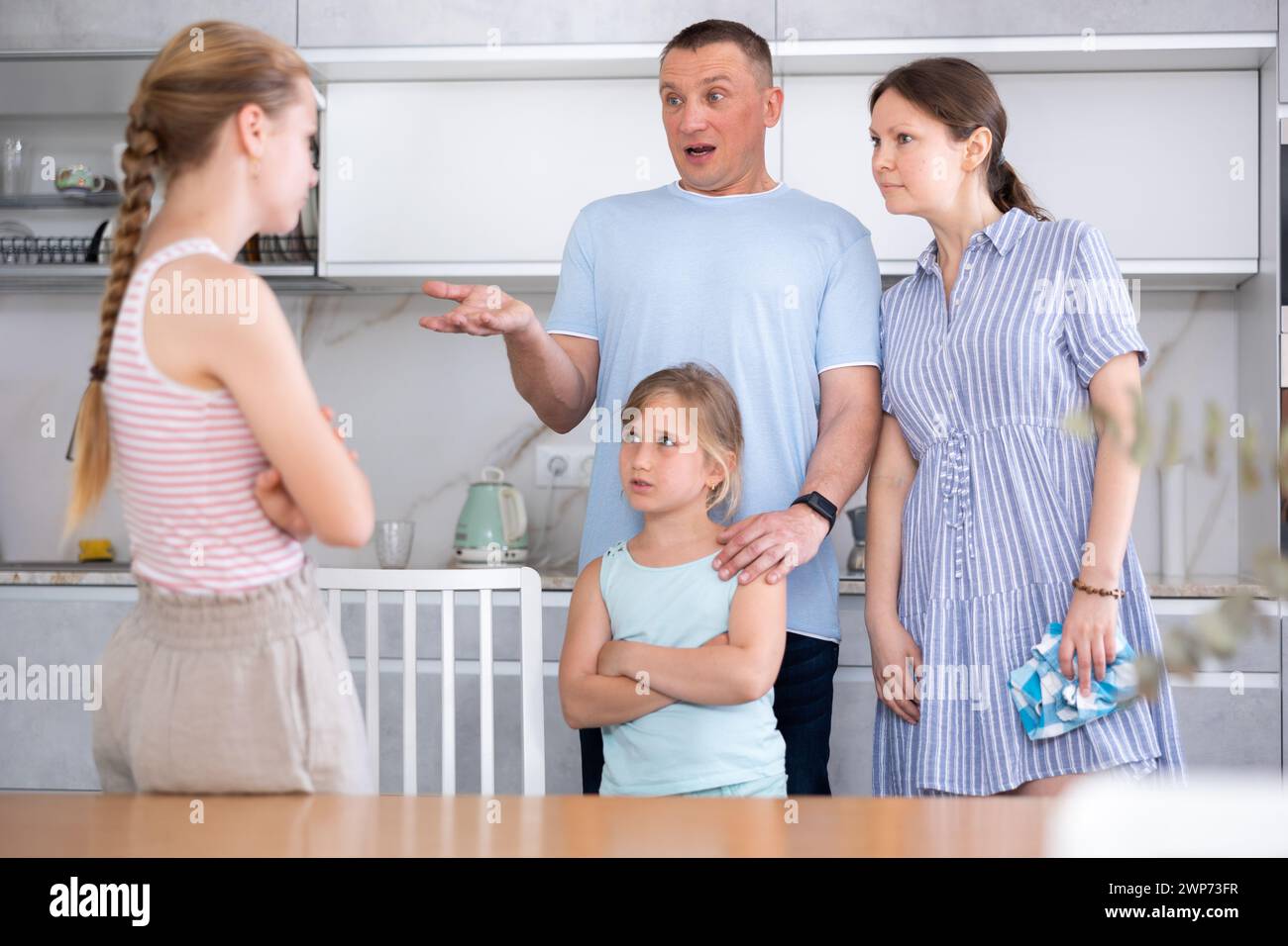 Displeased mother and father reprimanding eldest teenage daughter Stock ...