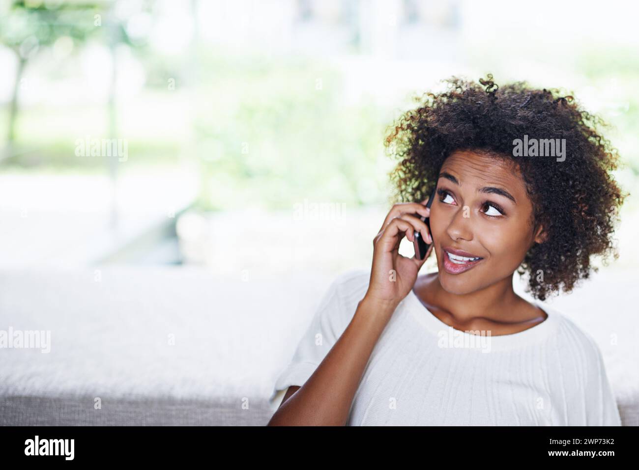 Face, surprise phone call and black woman in living room of home with ...