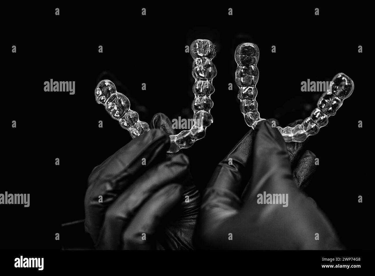 Invisible dental teeth brackets tooth aligners on black Plastic braces ...