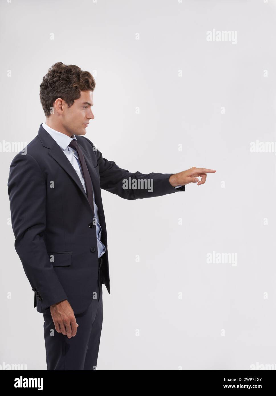 Pointing, mockup and businessman in studio for direction hand gesture ...