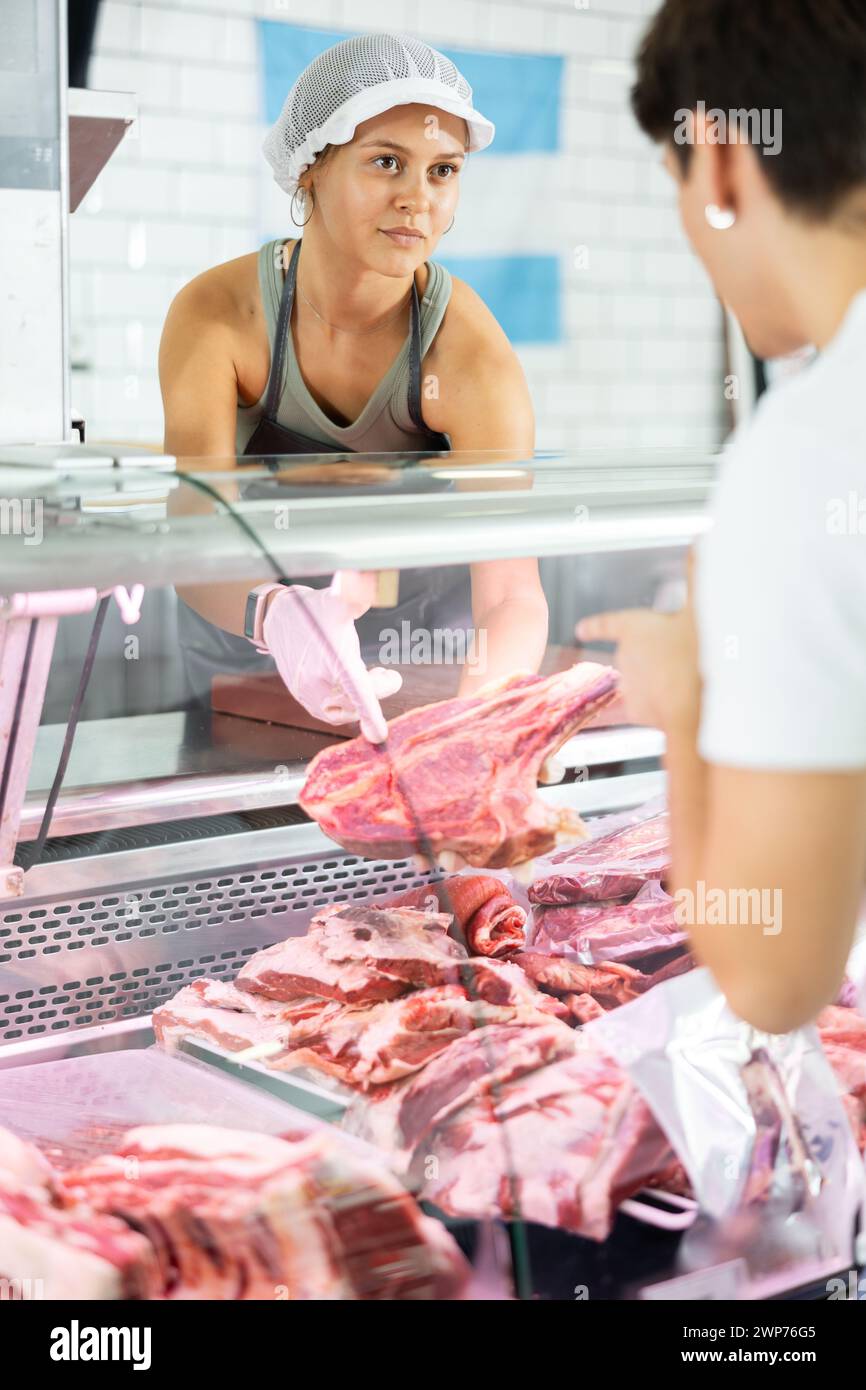 female butcher skillfully presents Stock Photo - Alamy