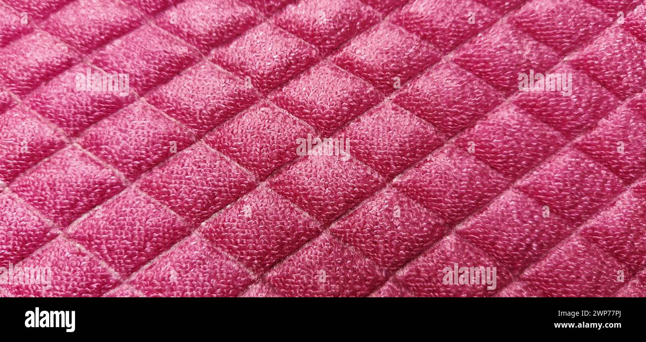 Beautiful fabric of red color with a cold shade sewn by rhombuses ...