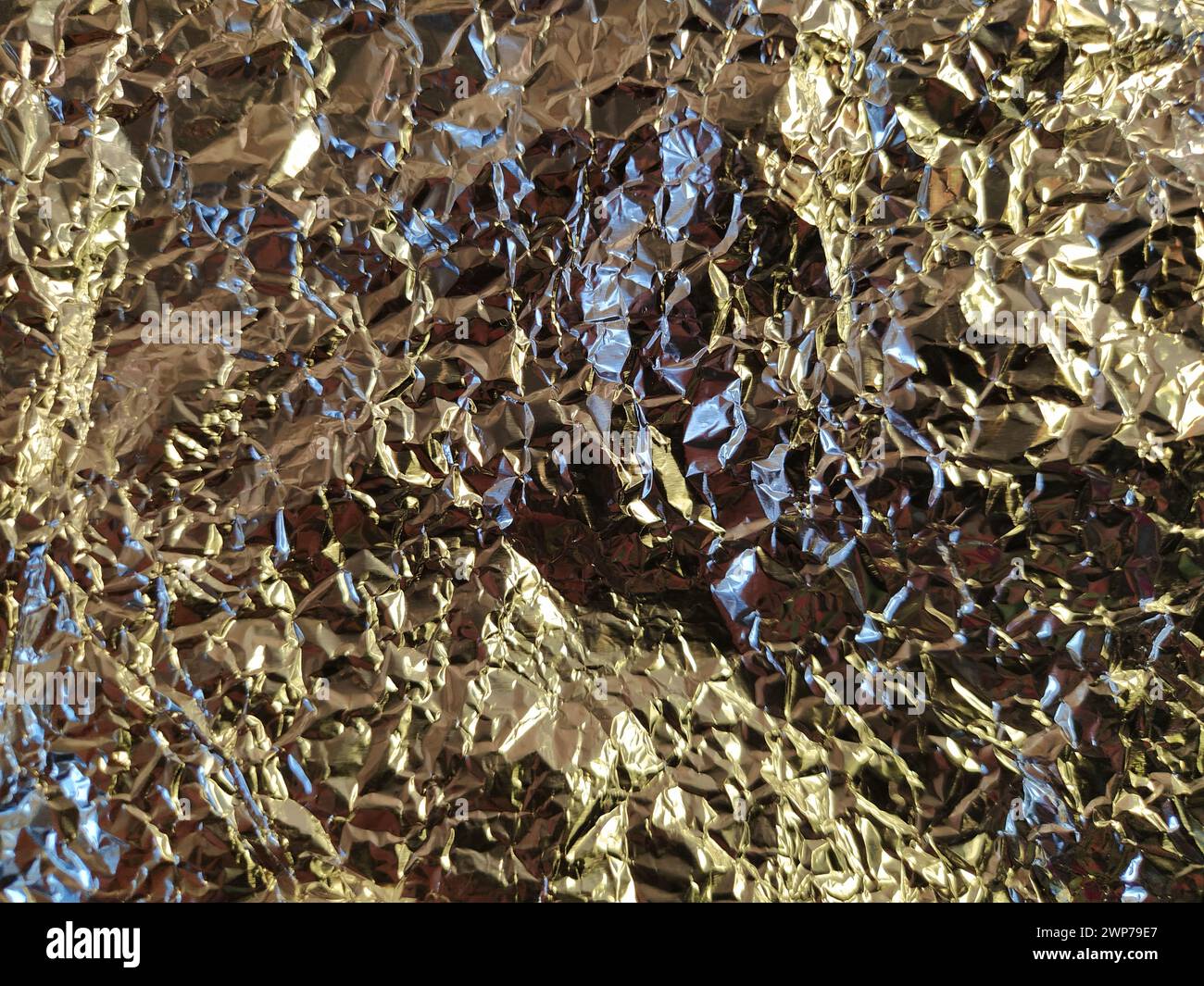 Crumpled aluminum foil. Reflection and refraction of light in different ...
