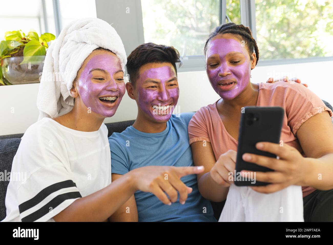 Three friends enjoy a spa day at home, laughing and taking selfies ...