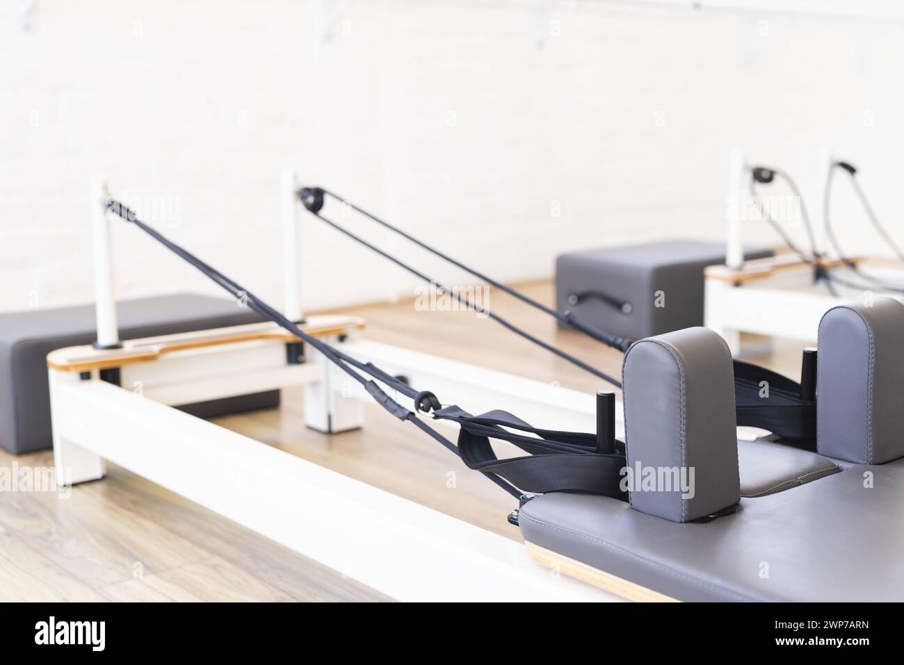 Pilates reformer machines await users in a bright studio Stock Photo ...