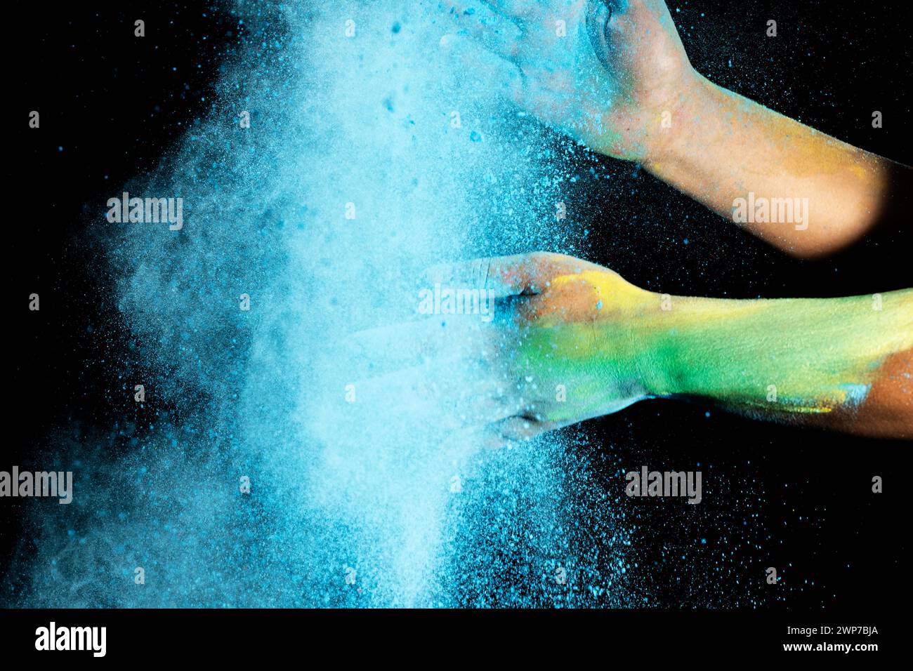 Human hand with colorful Holi powder on a black background. Holi ...