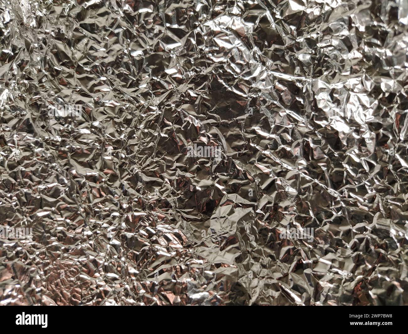 Crumpled aluminum foil. Reflection and refraction of light in different ...