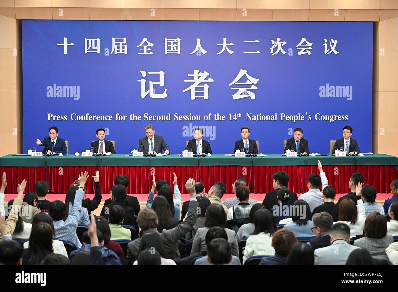 Beijing, China. 6th Mar, 2024. Journalists raise hands to ask questions ...