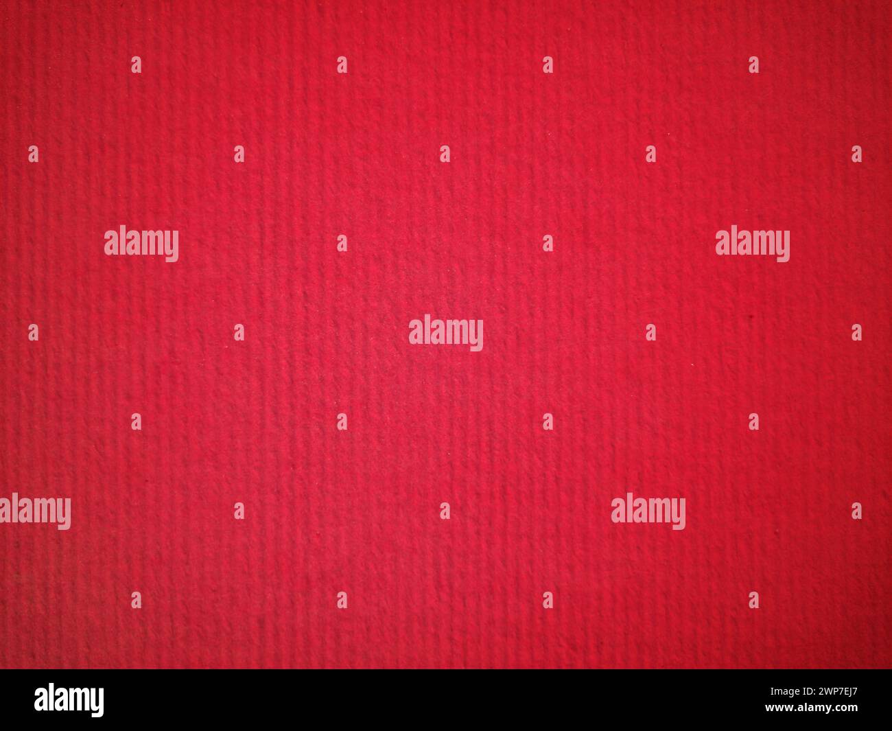 A sheet of bright red paper with barely noticeable vignetting around ...