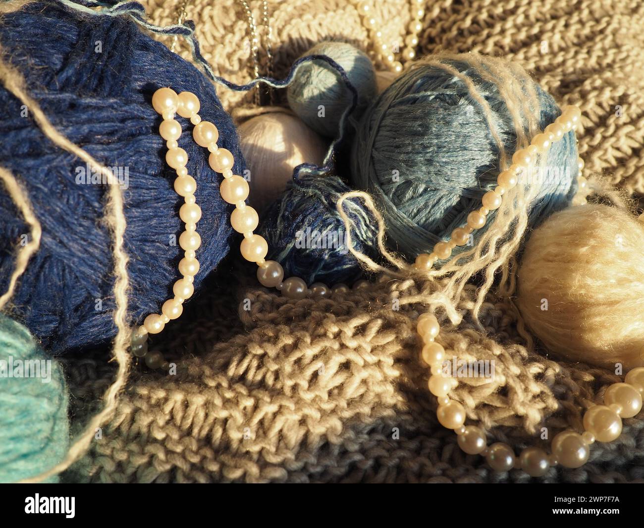 Cuts of yarn and thread on the background of a knitted product. Beige ...