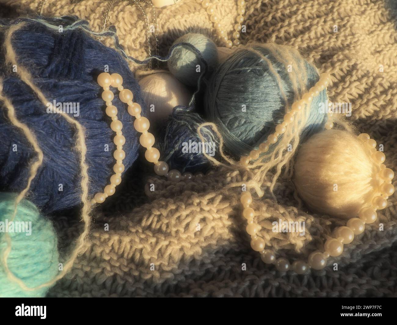 Cuts of yarn and thread on the background of a knitted product. Beige ...