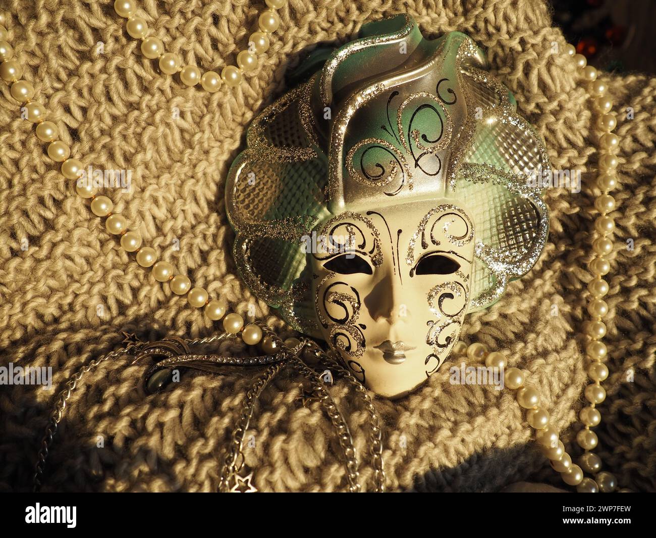 Carnival mask on a knitted background with beads and sparkles. Carnival ...