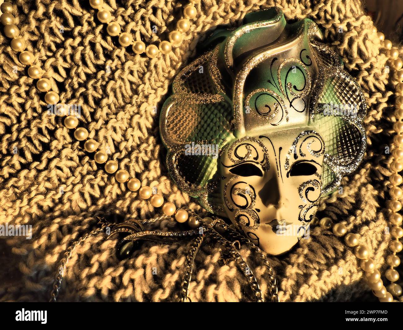 Carnival mask on a knitted background with beads and sparkles. Carnival ...