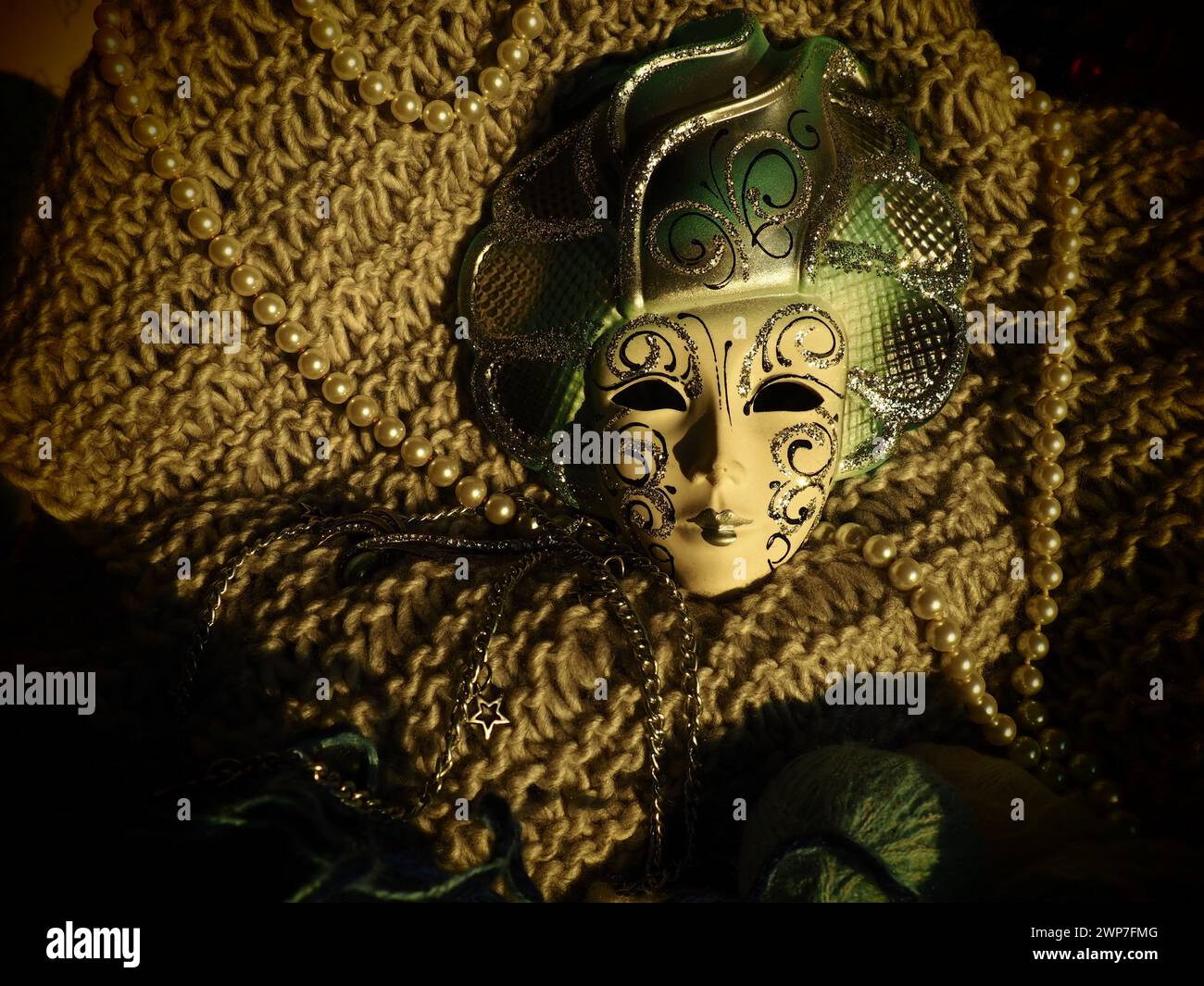 Carnival mask on a knitted background with beads and sparkles. Carnival ...