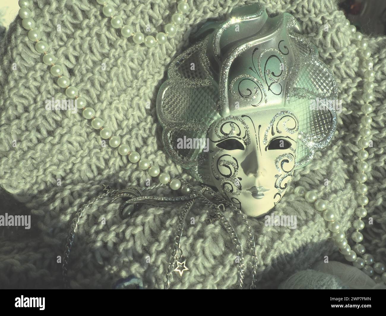 Carnival mask on a knitted background with beads and sparkles. Carnival ...