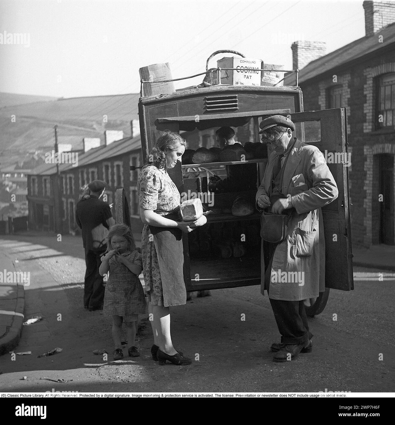 Buying bread 1945. The village of Tylorstown in the Rhondda valley in ...