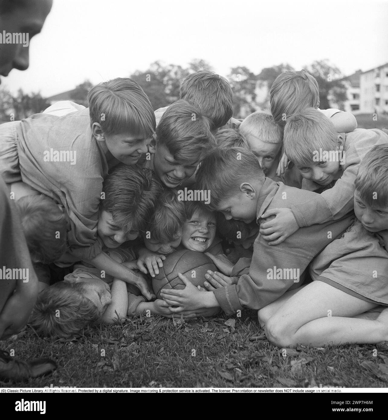 Rugby 1940. A group of young rugby players all on top of one smiling ...