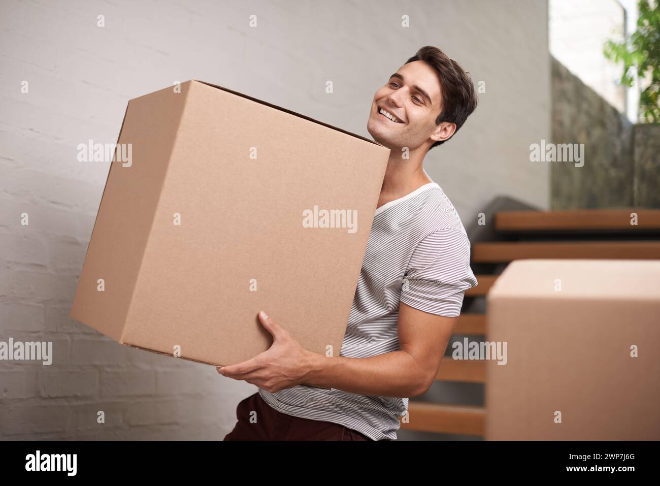 Man, moving boxes and new home by stairs with smile, fresh start and ...