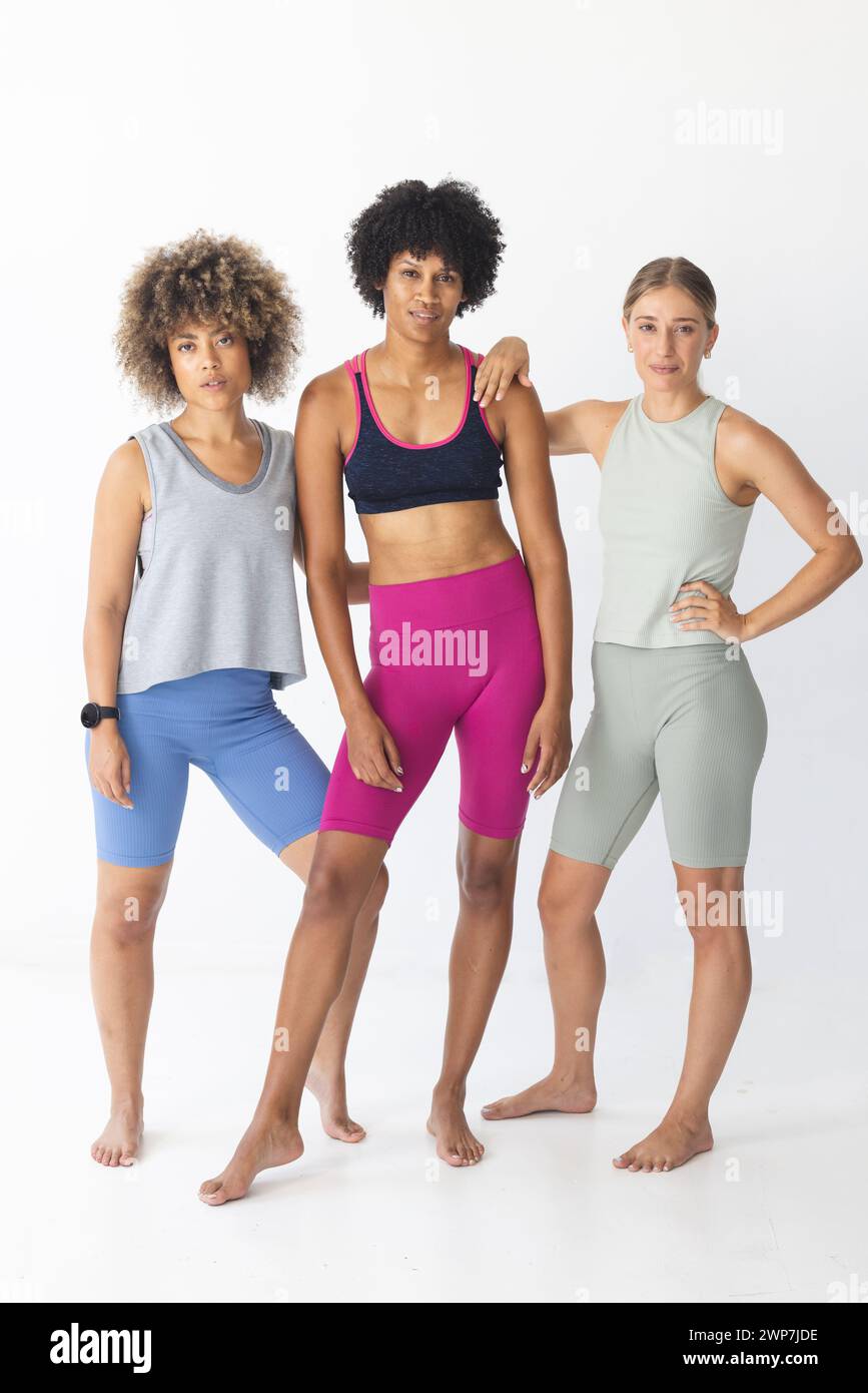 Three fit women pose confidently in athletic wear Stock Photo - Alamy