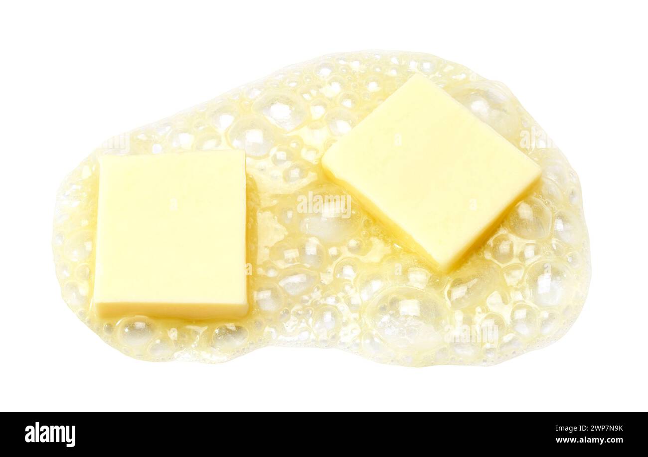 Two pieces of butter melting isolated on white background Stock Photo ...