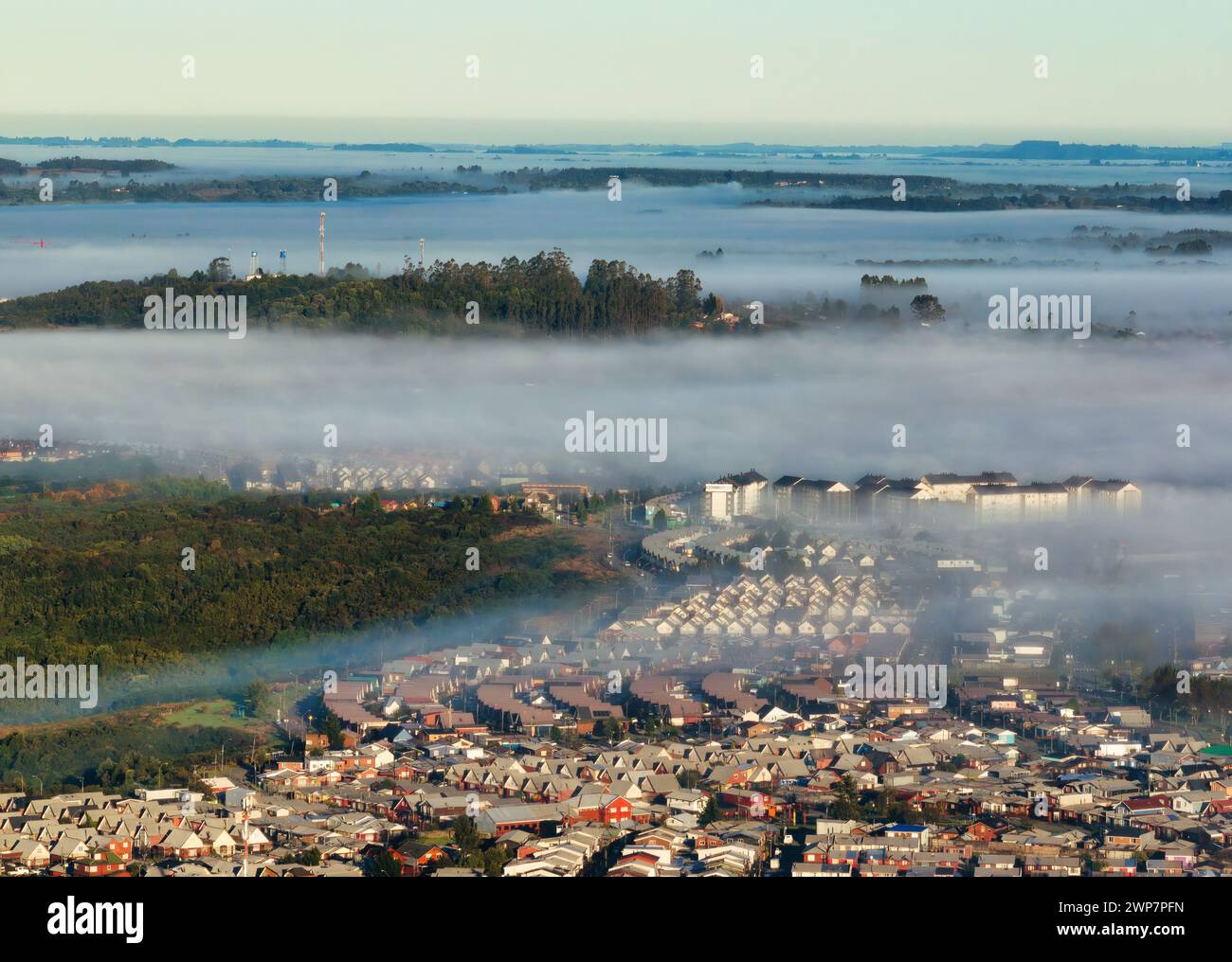 An aerial view of the suburbs of Puerto Montt in the foggy morning ...