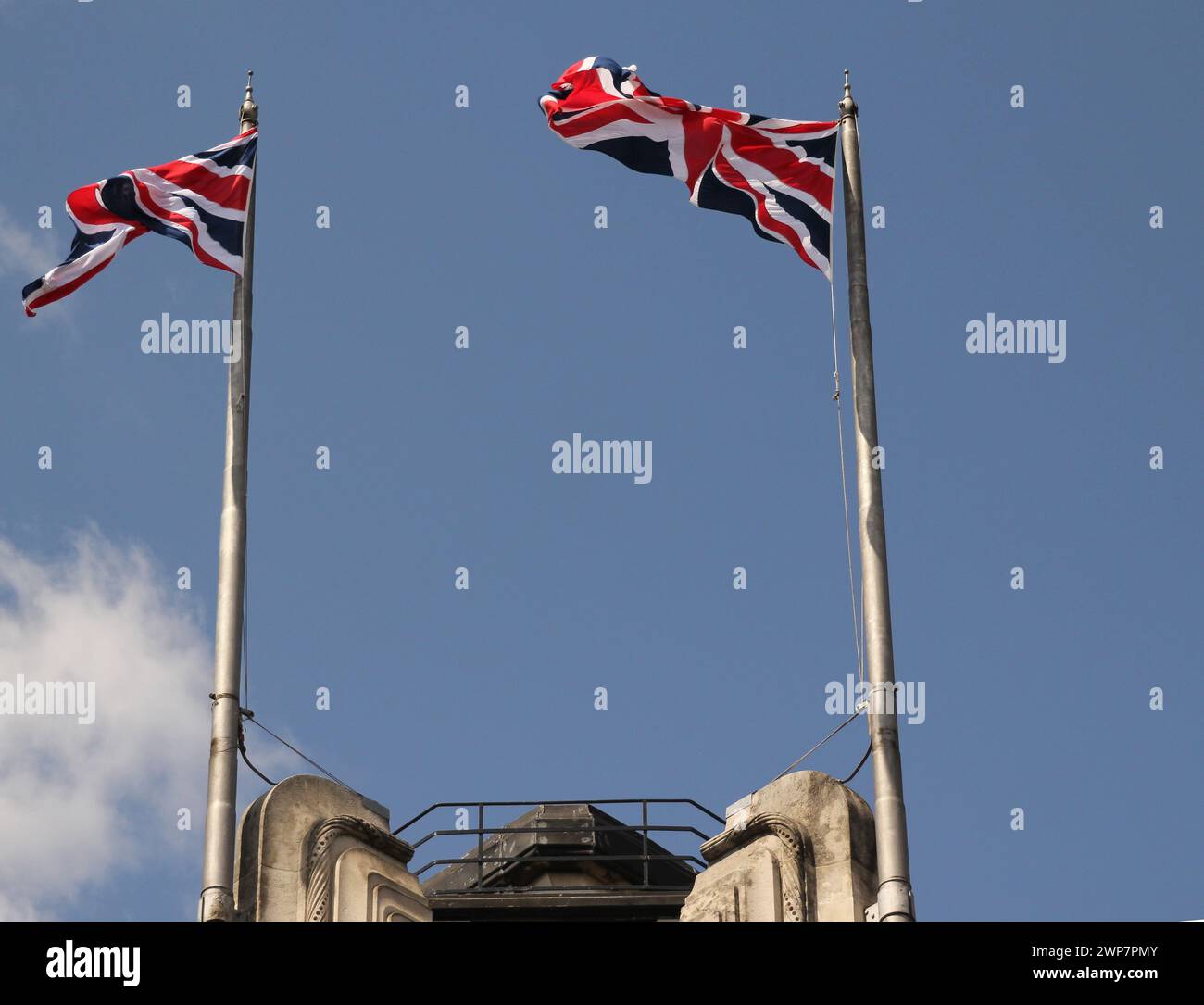 Some Union Jack flags in London waving on a building in sunlight Stock ...