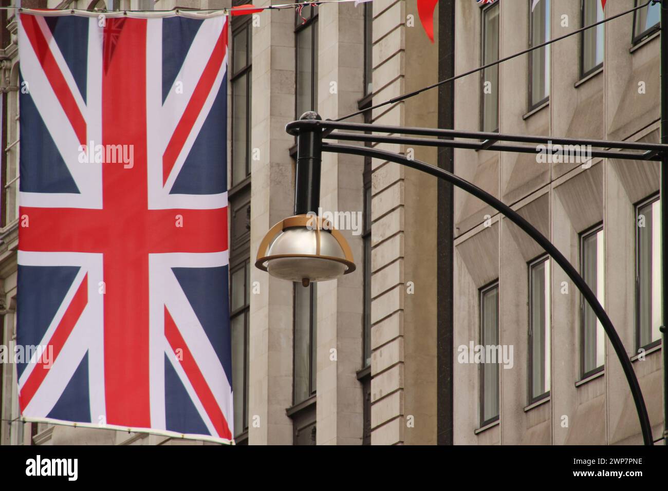 A Union Jack flag displayed in an urban setting for an event Stock ...