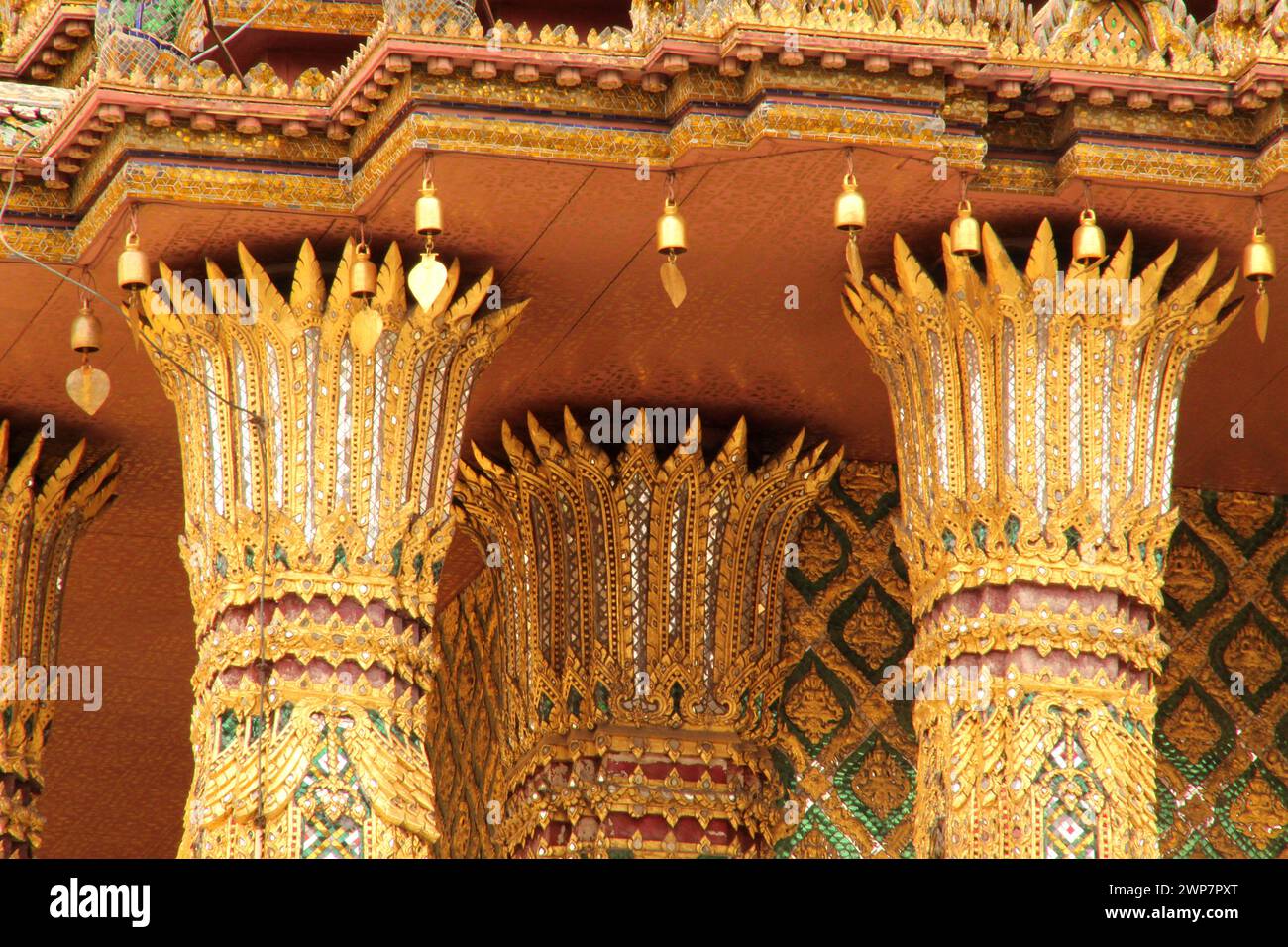 Some golden and green pillars adorned with ornate gold decorations ...