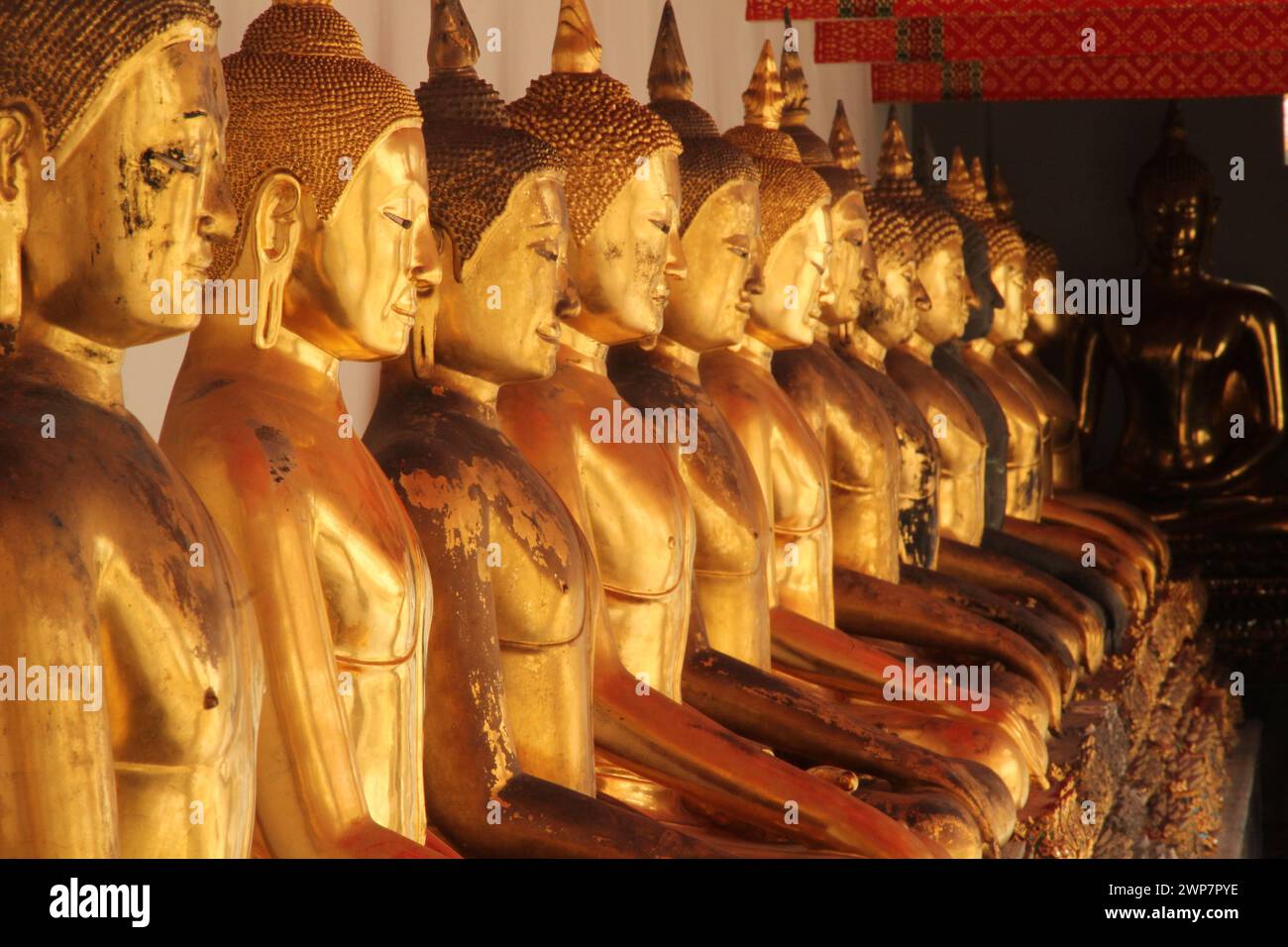 Golden statues in a row in Bangkok temple Stock Photo - Alamy