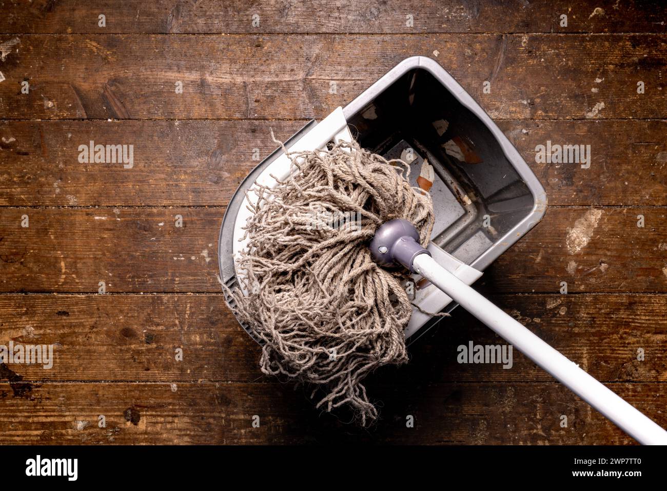 floor cleaning mop in mop bucket on a wooden floor Stock Photo - Alamy