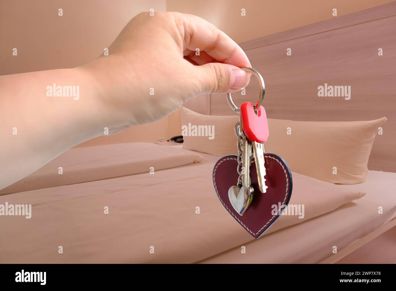hotel bedroom with neatly made double bed covered in clean white linens ...
