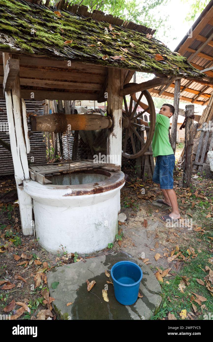 Child getting water from well hi-res stock photography and images - Alamy