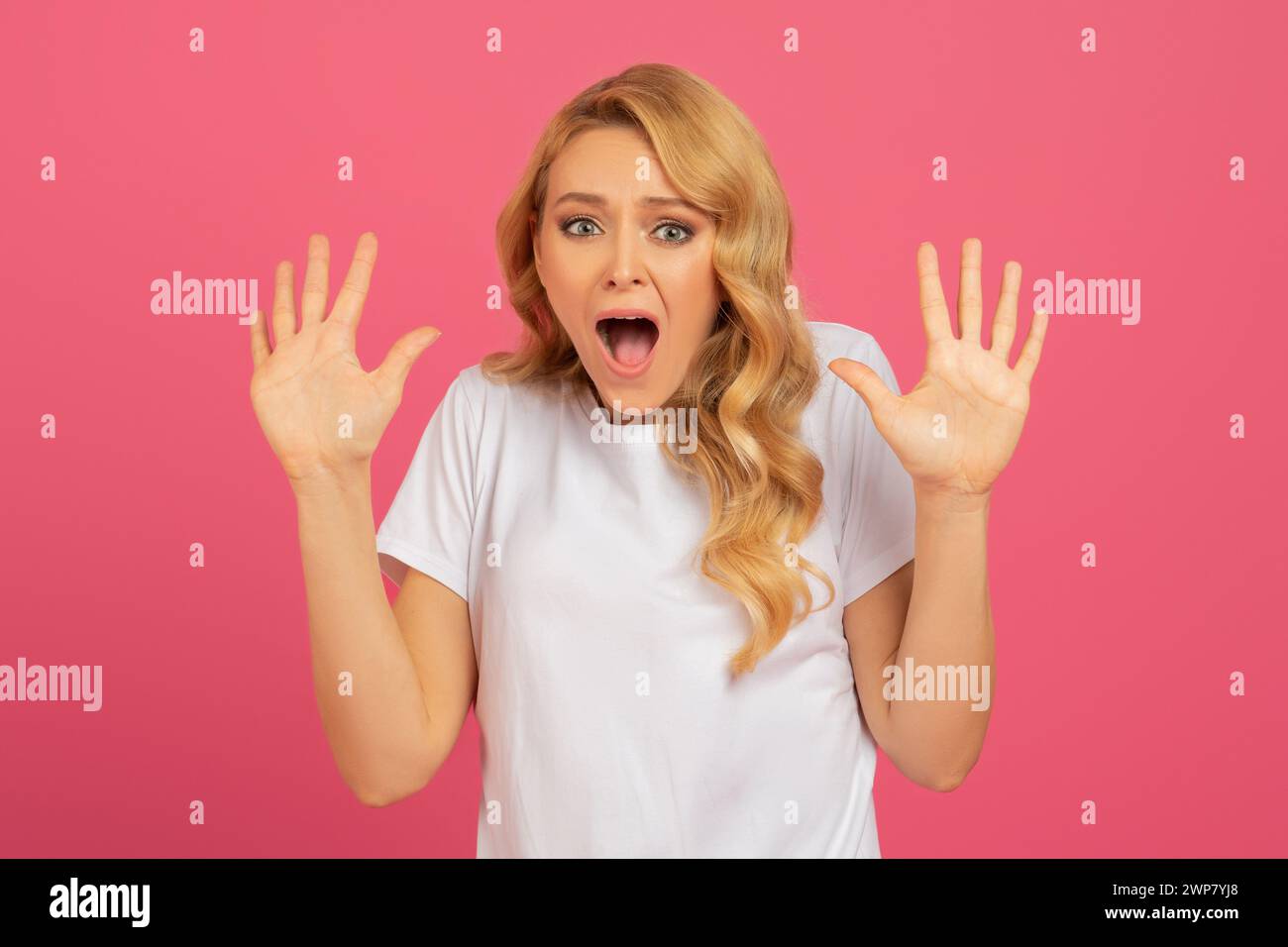 Blonde woman raises hands hi-res stock photography and images - Alamy