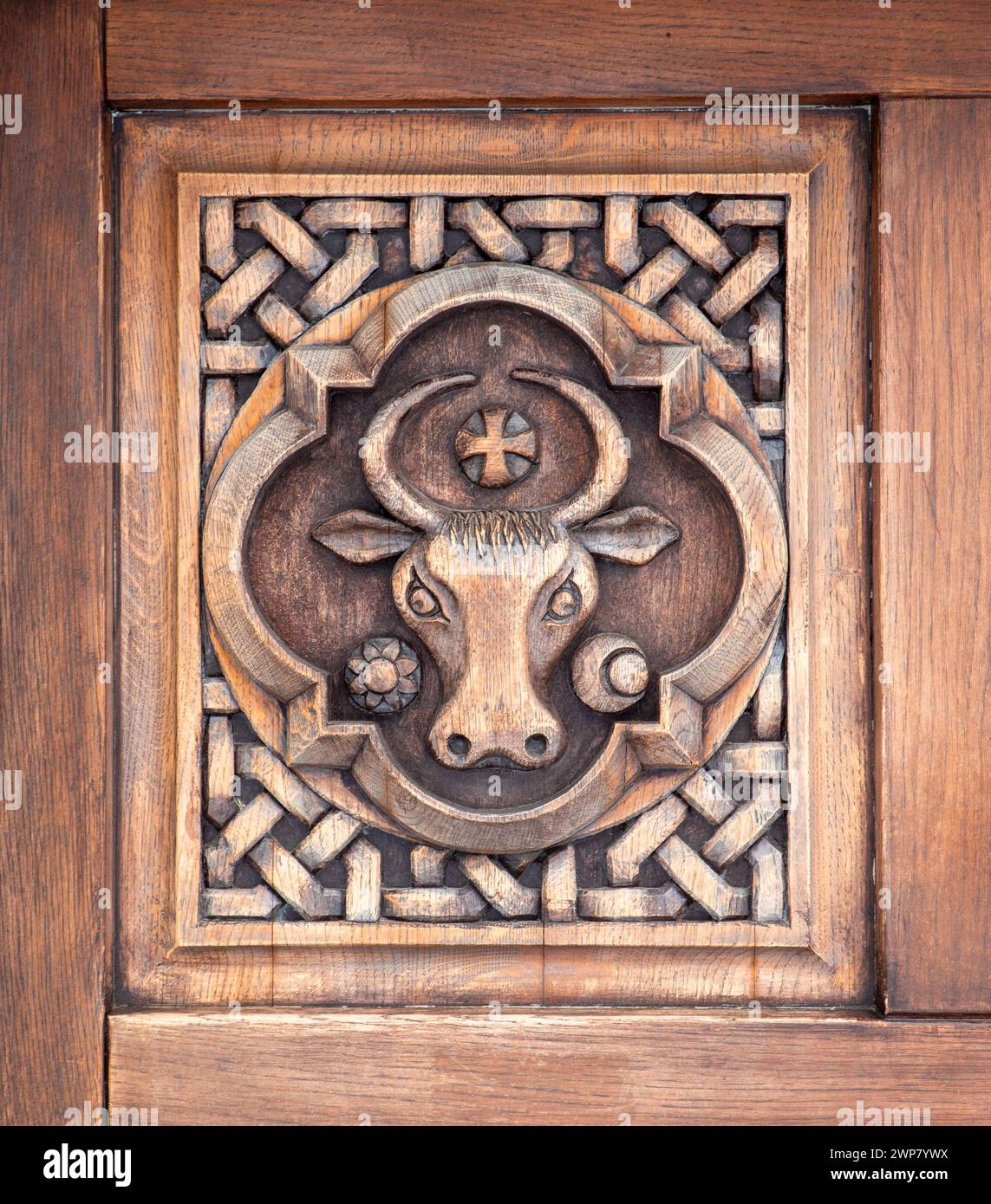 A Vintage wooden door featuring a cow design Stock Photo - Alamy
