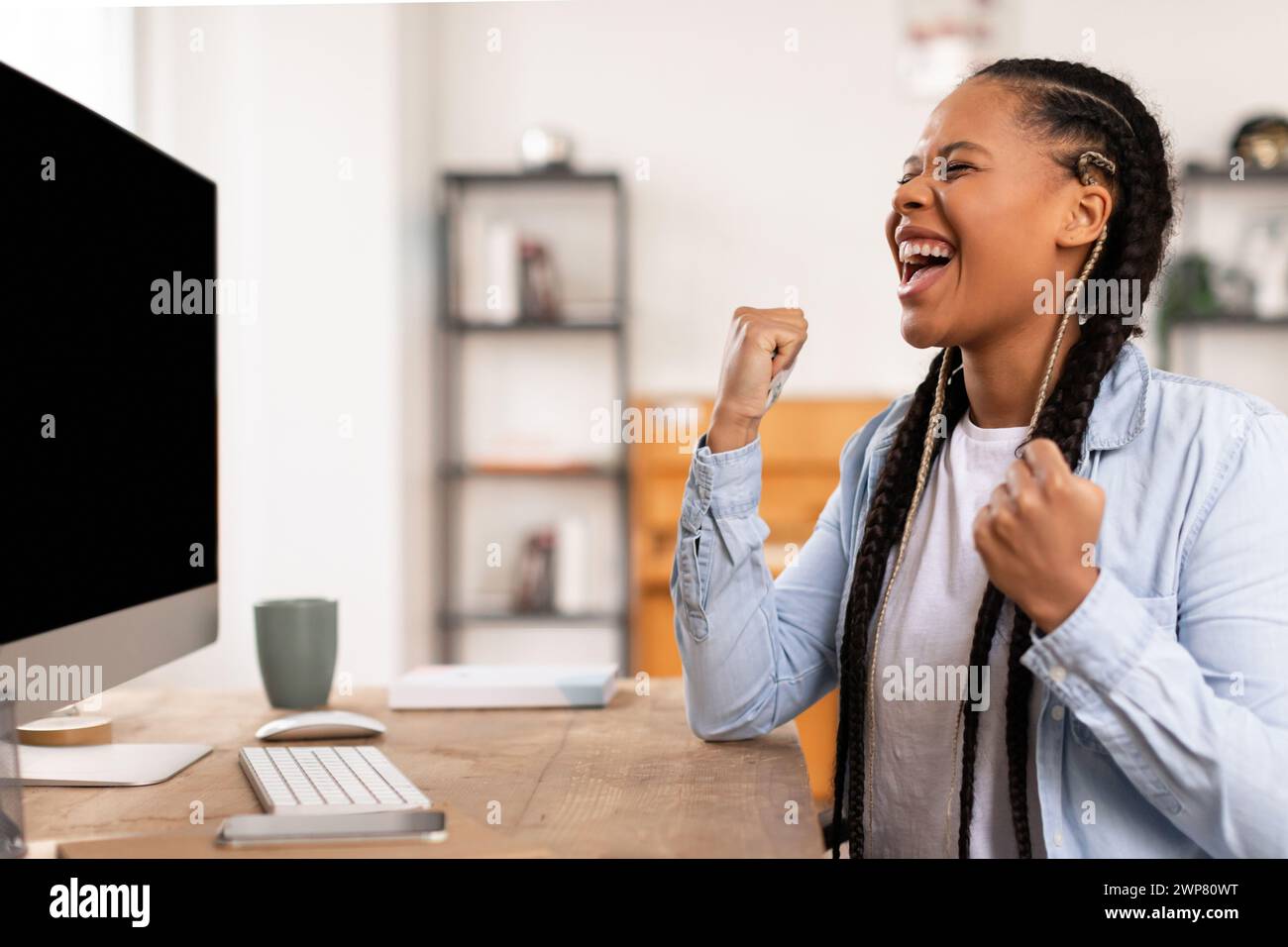 Black teen student lady celebrates achievement in front of computer ...
