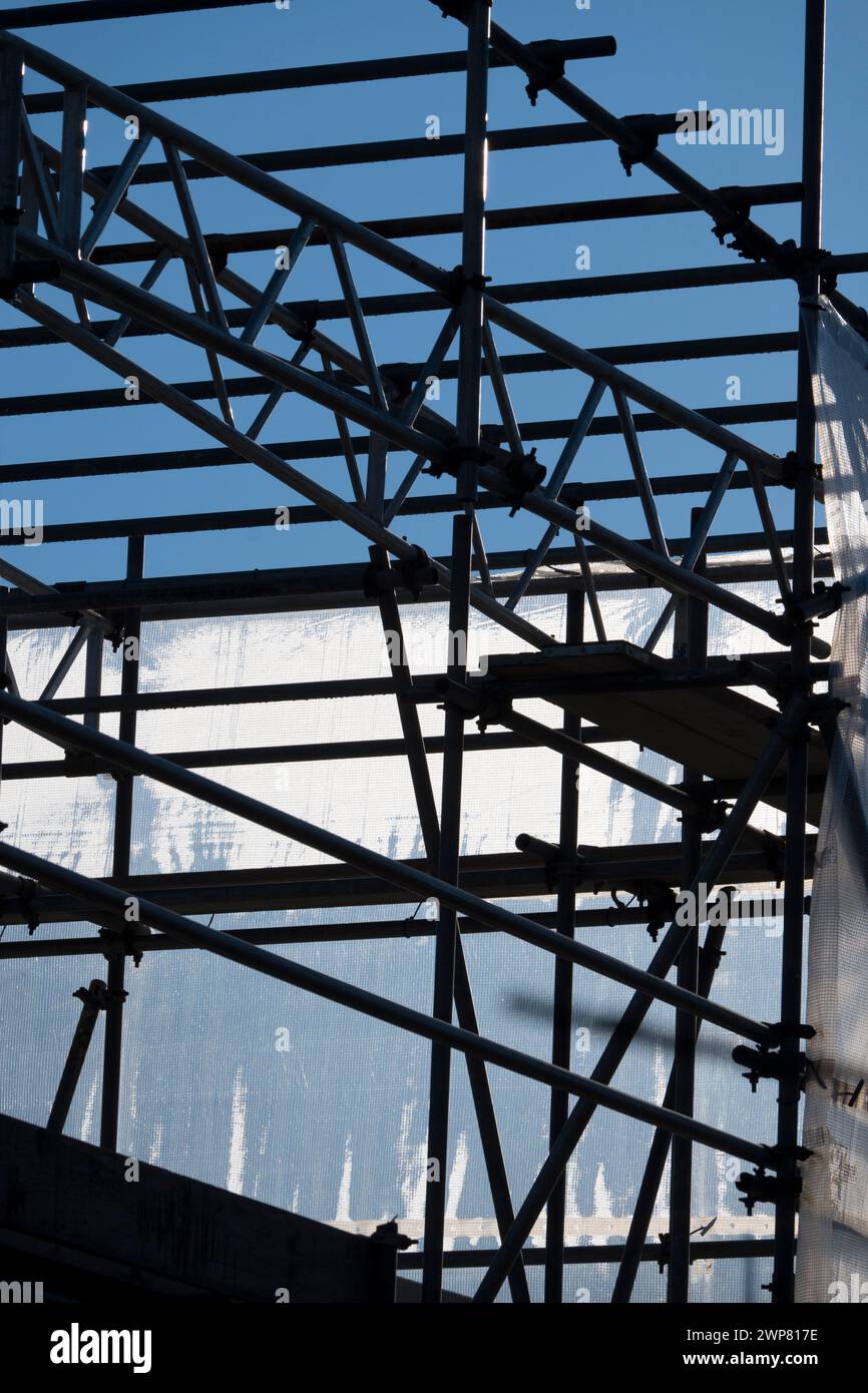 Scaffolding and tarpaulins - at a construction site for a new factory ...