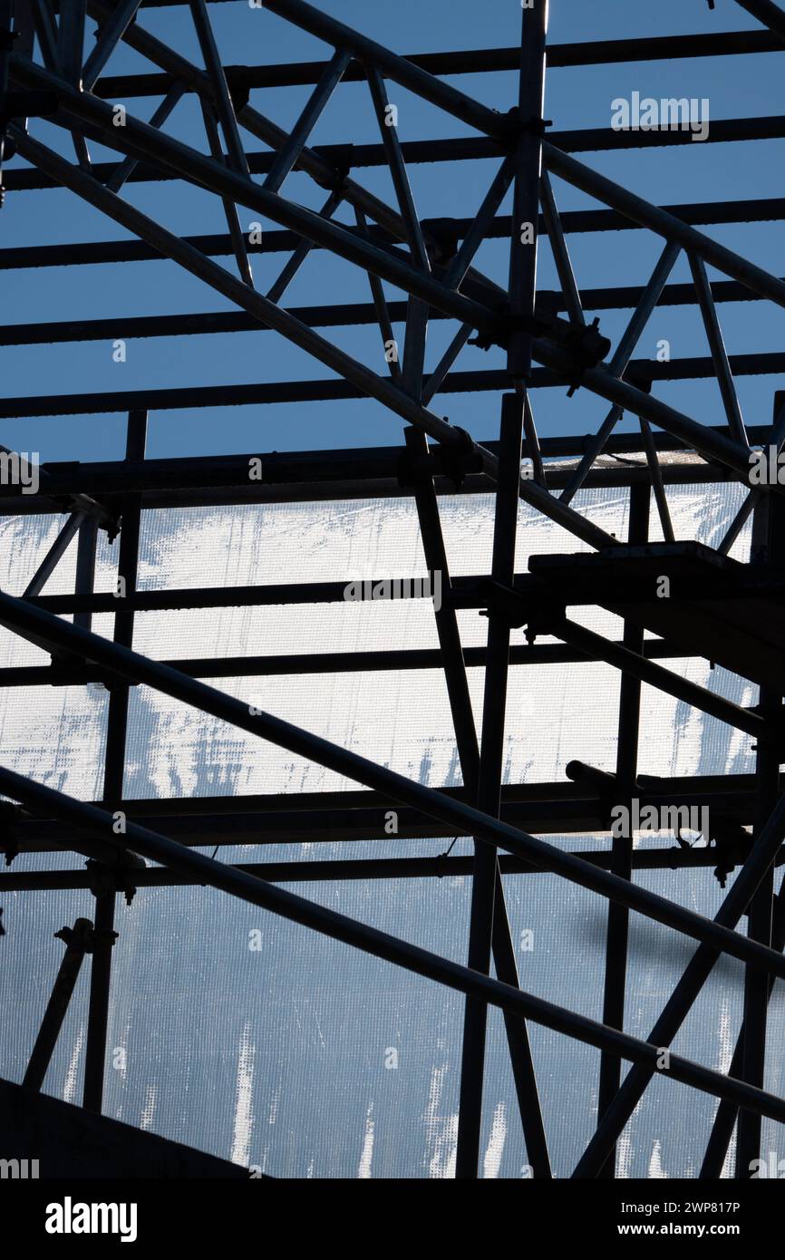 Scaffolding and tarpaulins - at a construction site for a new factory ...