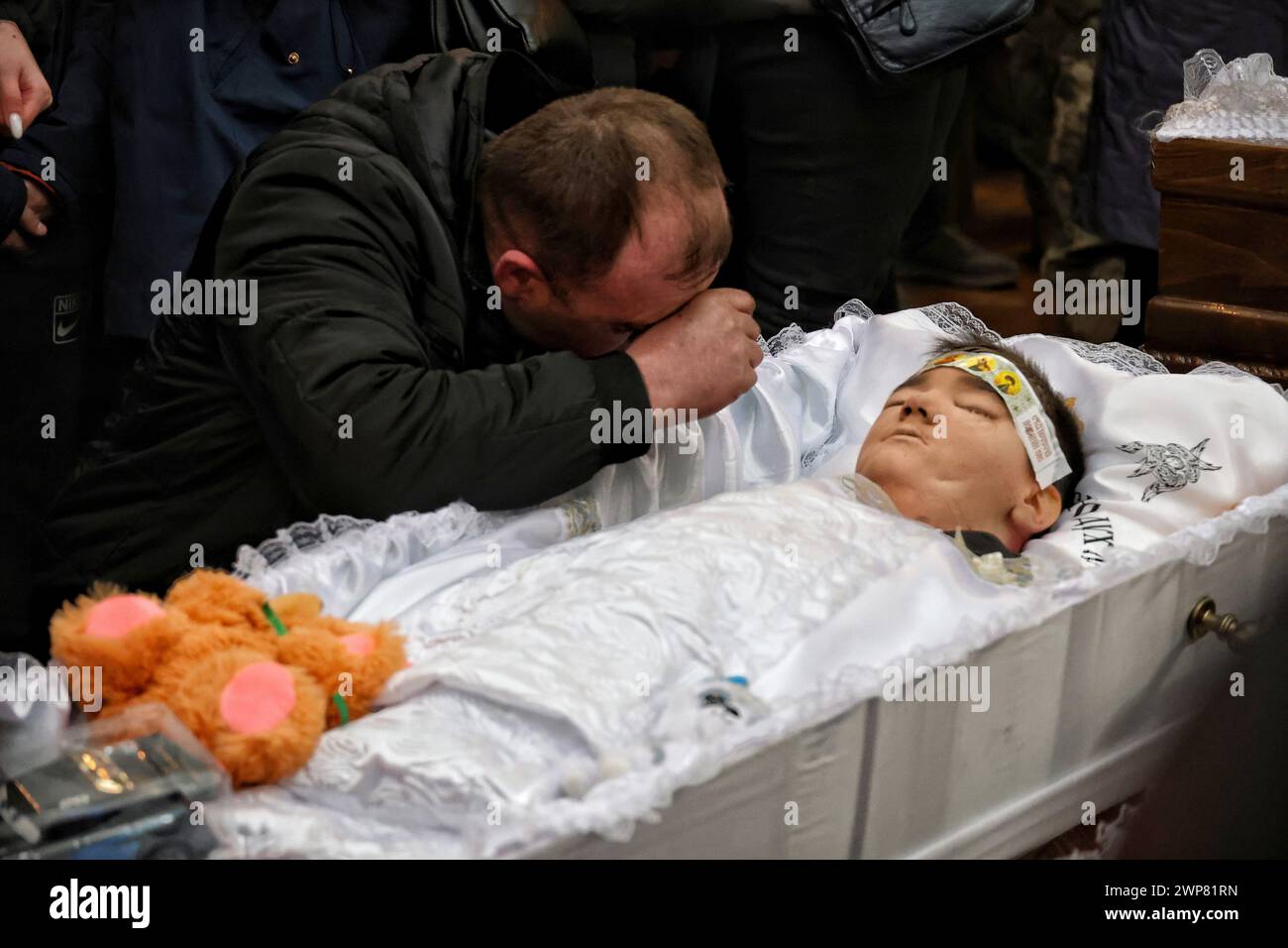 RAUKHIVKA, UKRAINE - MARCH 5, 2024 - A man cries at the coffin during a ...