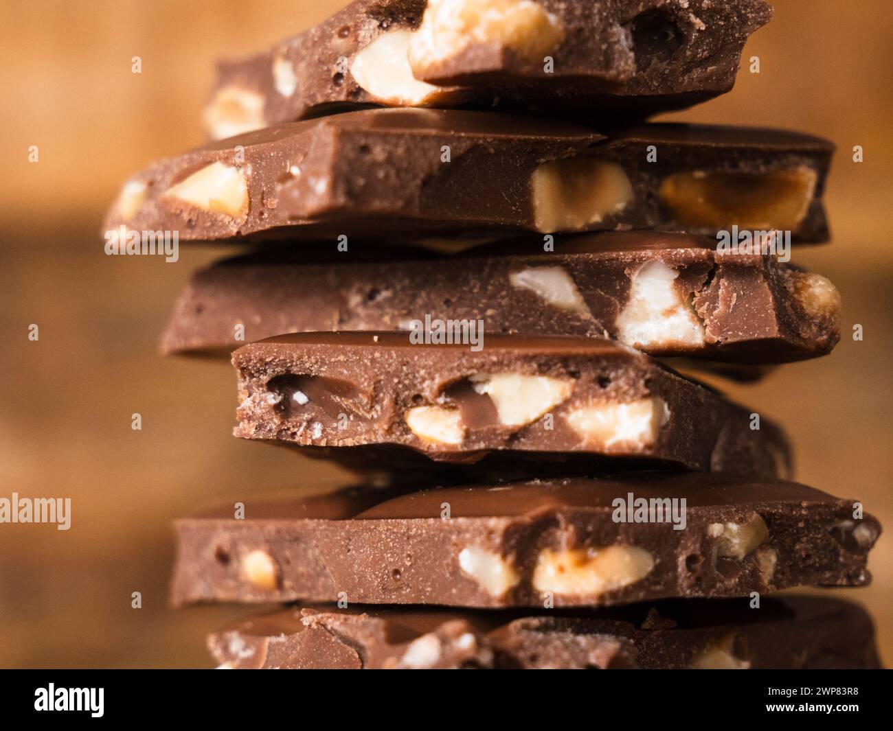 A pile of chocolate pieces with nuts stacked together Stock Photo - Alamy