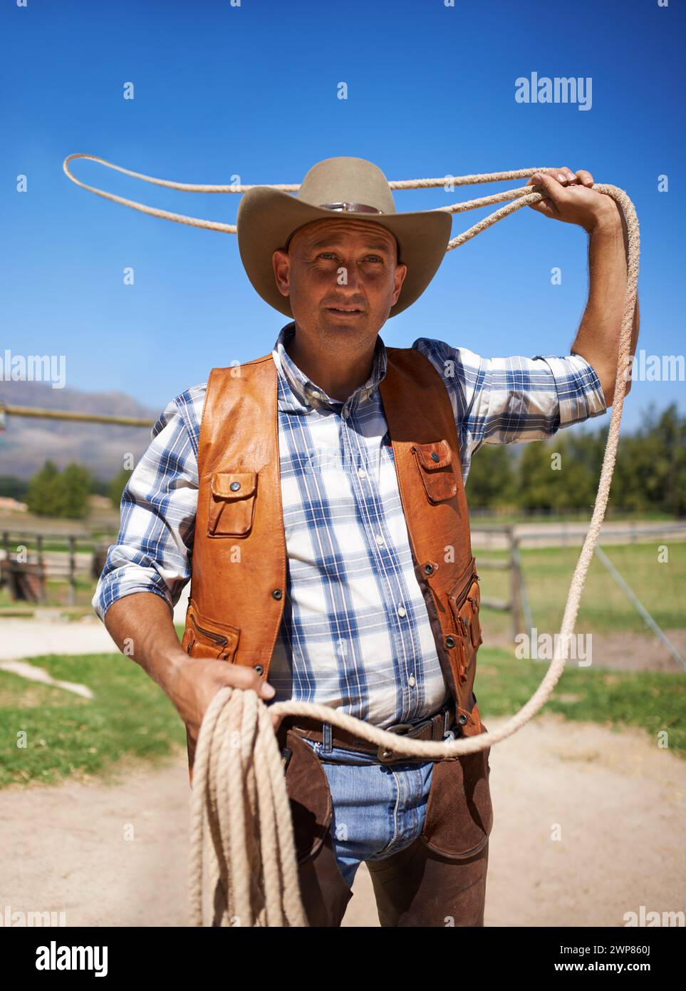 Cowboy, ranch and lasso in outdoor, sun and straps for wrangler and ...