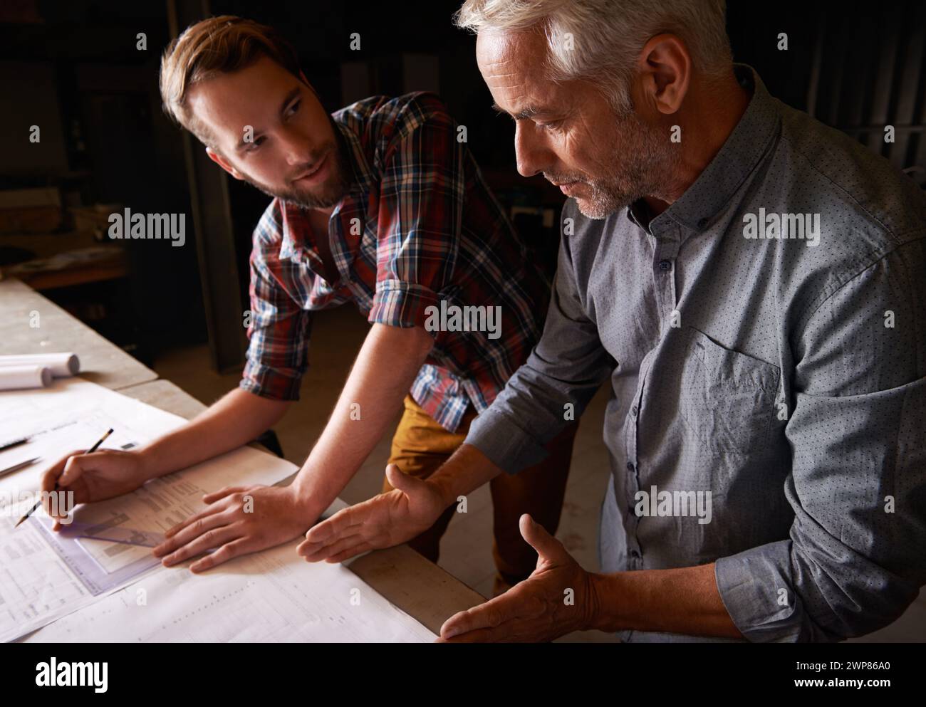 Carpenter, team and men with blueprint for discussion of construction ...