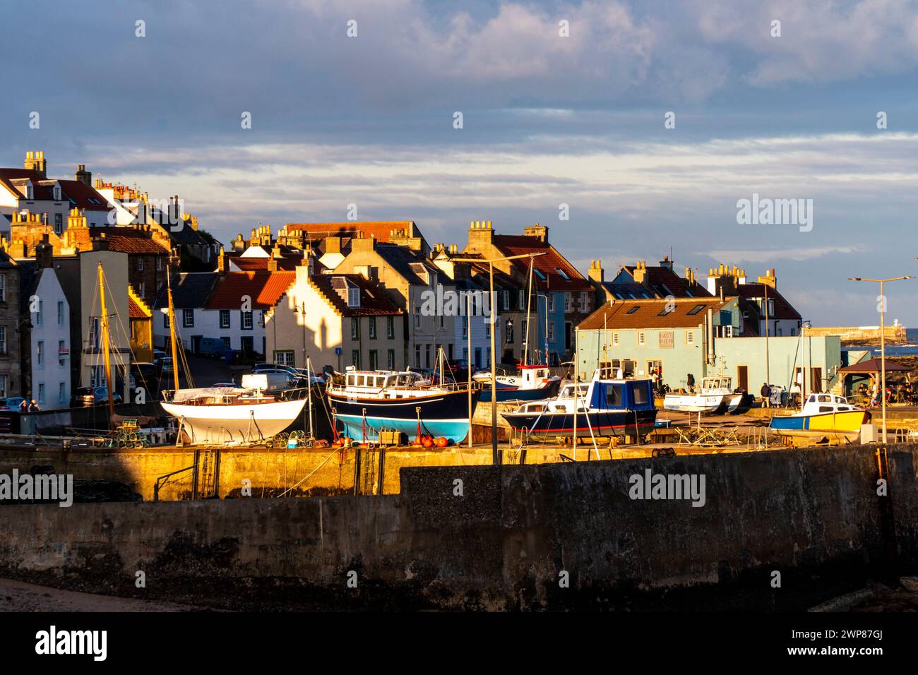 Multiple boats moored in a coastal town's harbor Stock Photo - Alamy