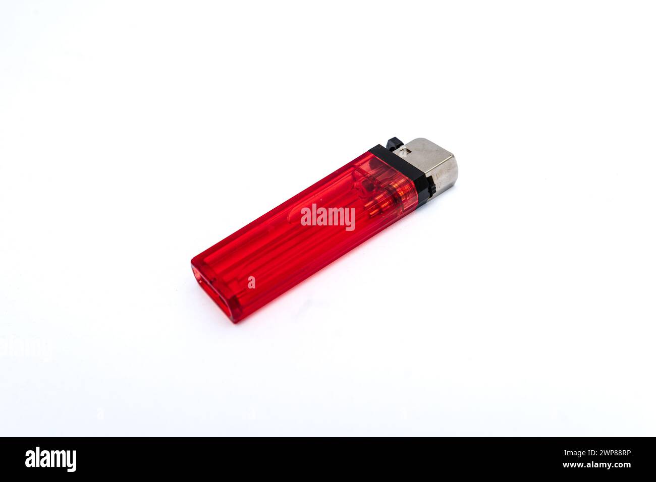 Cheap red cigarette gas lighter made of plastic isolated on white ...