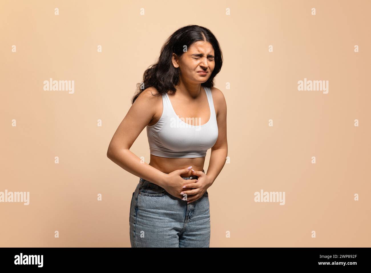 Stomach Pain. Sick young indian woman suffering from acute abdominal ...
